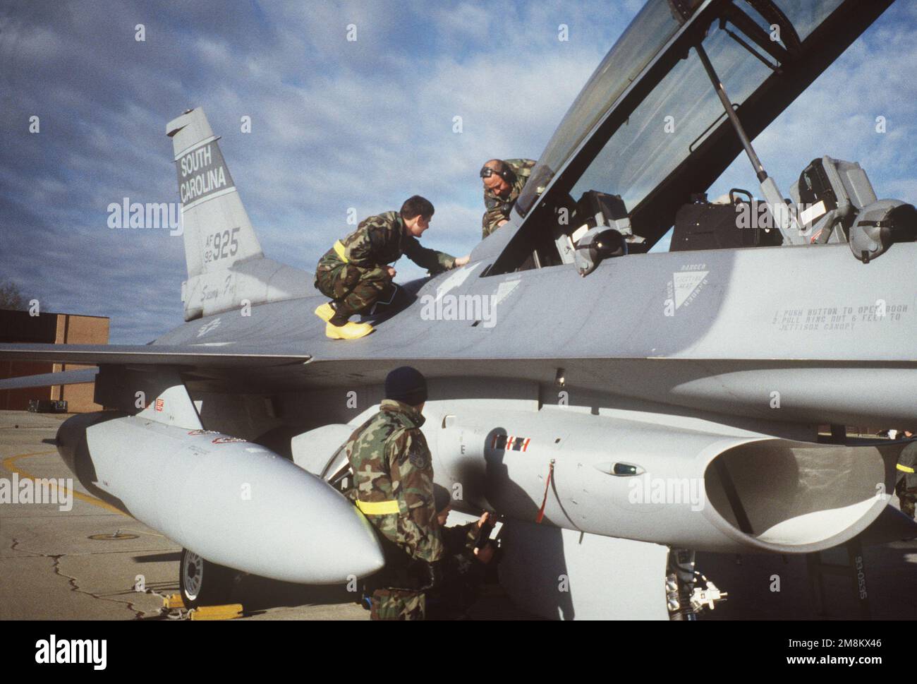 The crew CHIEF and two maintenance specialists work on F-16 Fighting ...