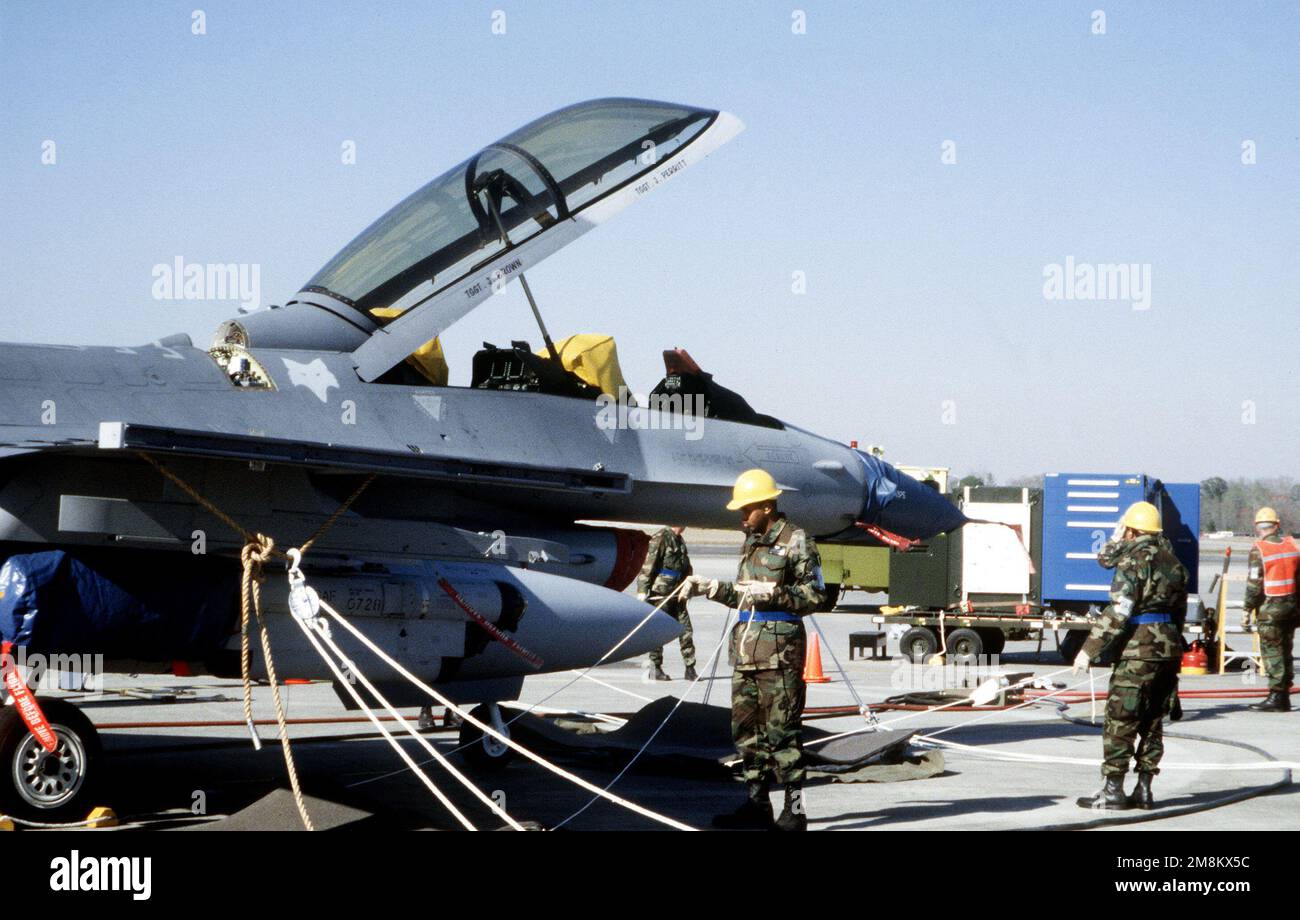 Two members of the crash recovery team hold the stabilizer cords for ...