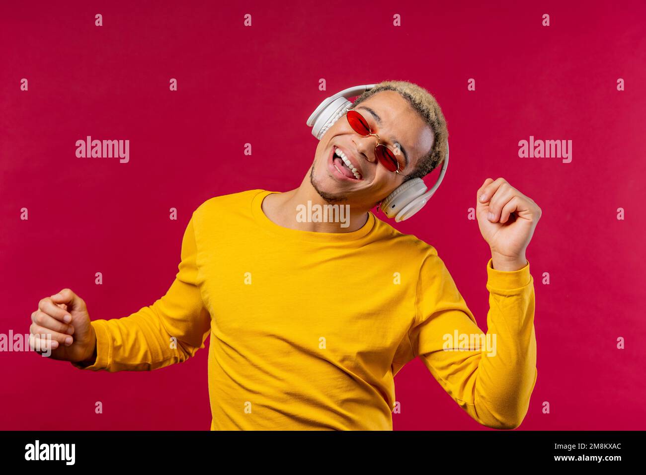 Positive american man listening music, enjoying dance with headphones ...