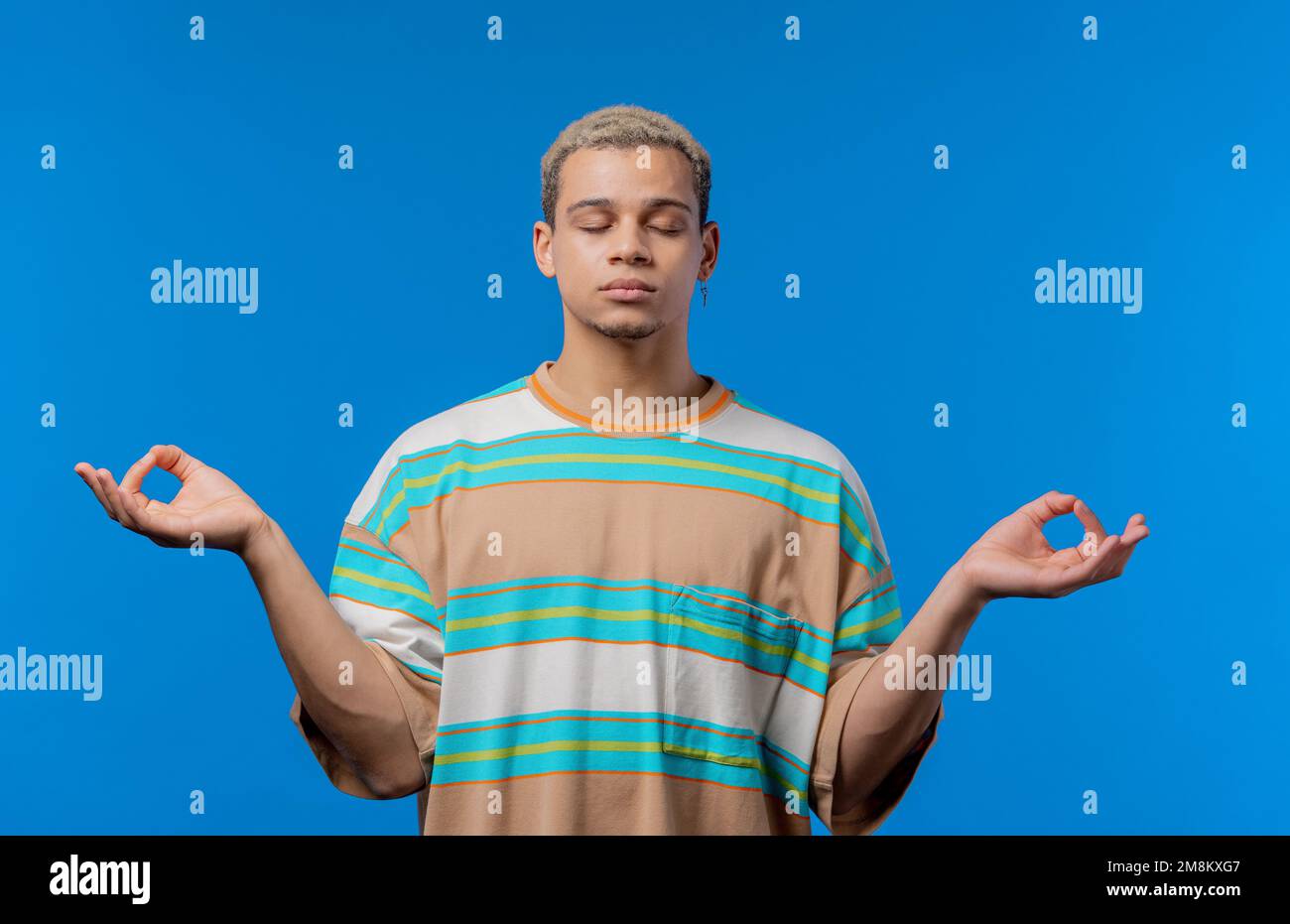 Calm man relaxing, meditating, refuses stress. Curly haired guy ...