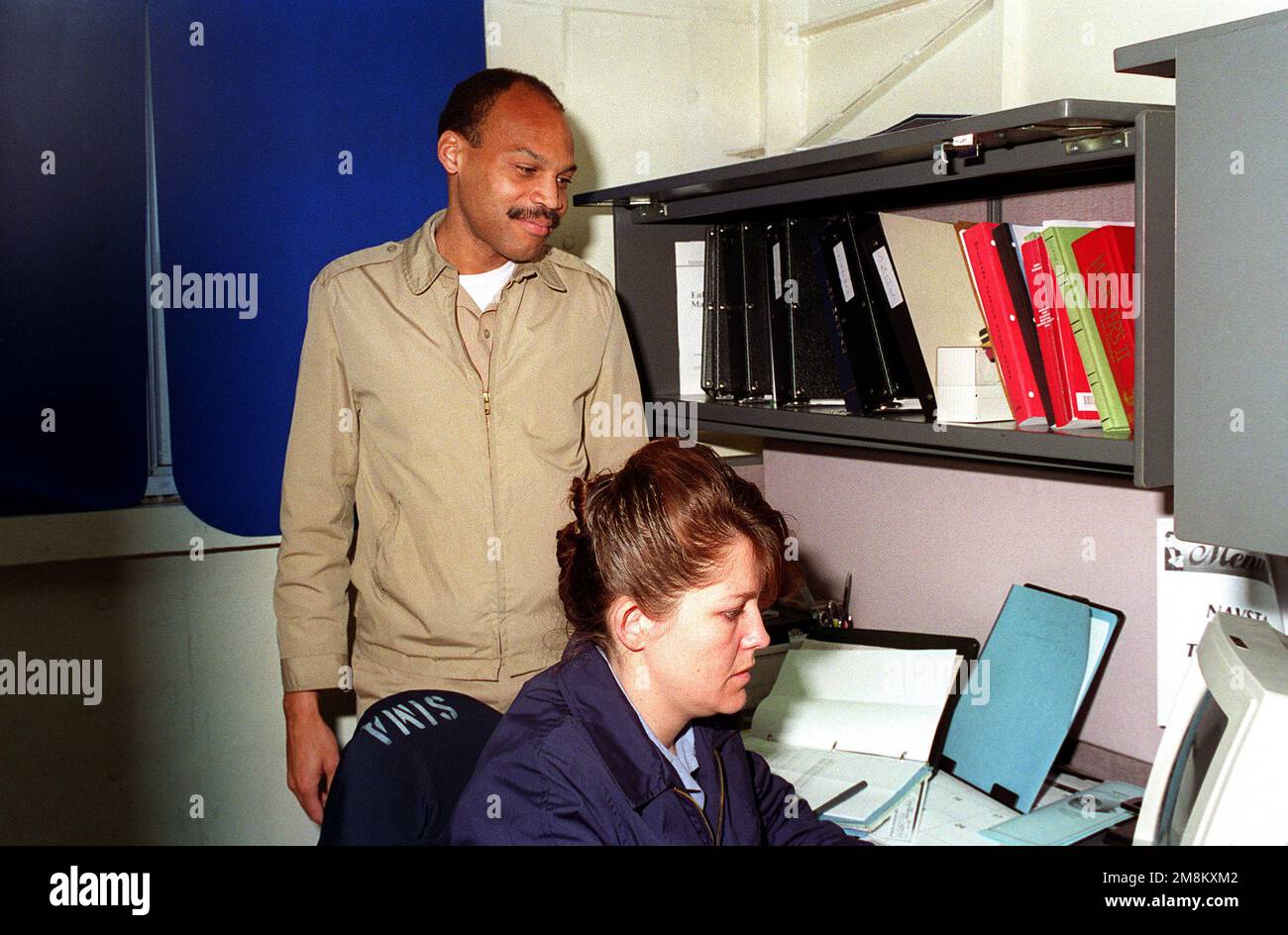 CHIEF Sonar Technician(G) (STGC) Mark Nelson looks over the shoulder of ...