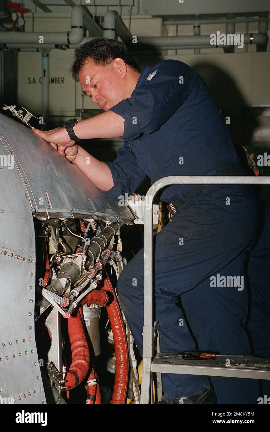 Aviation Machinist Second Class (AD2) Robert Brackhahn is shown ...
