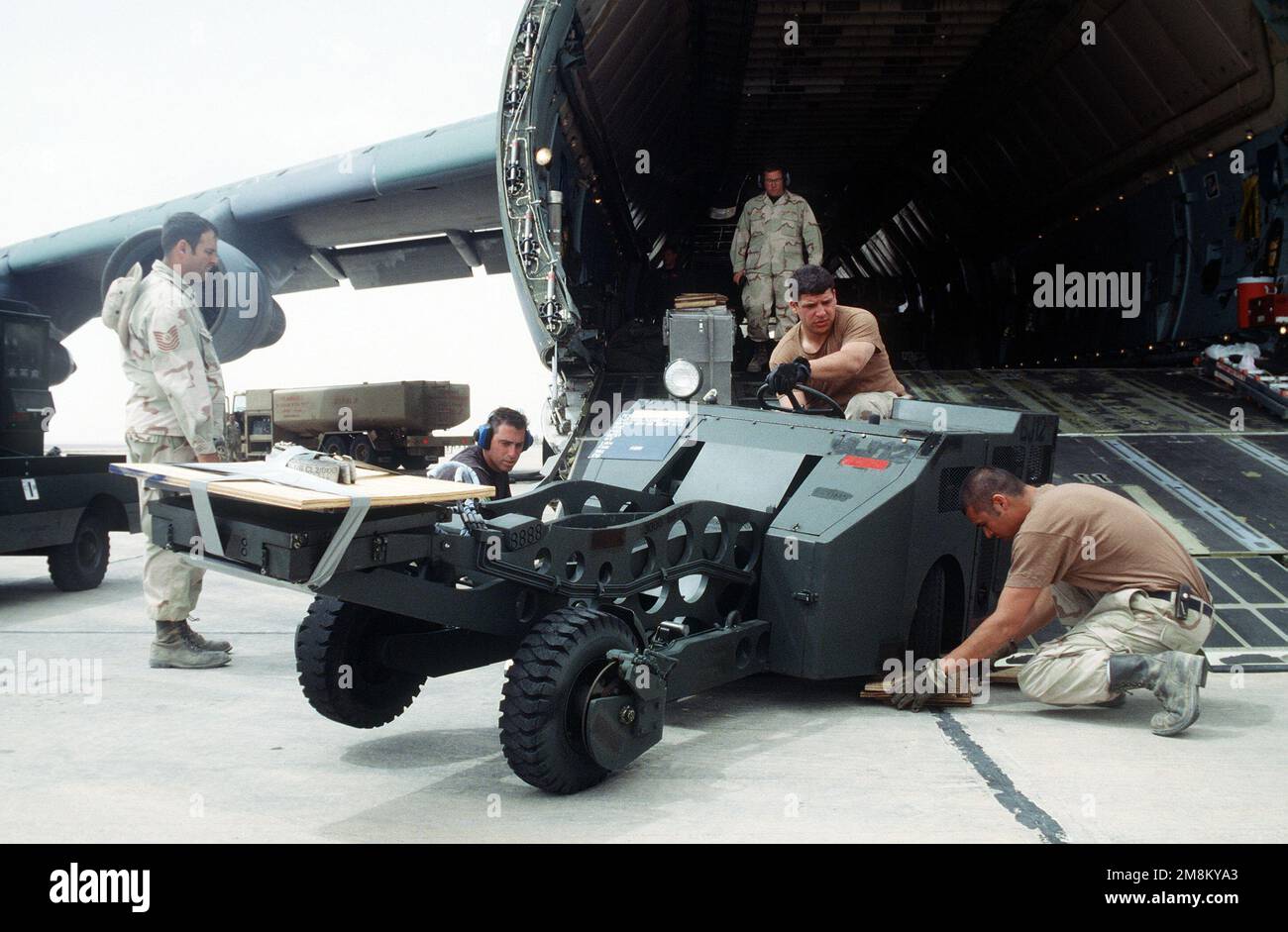An MJ-1 weapons loader is unloaded from a C-5 Galaxy from the 3rd ...