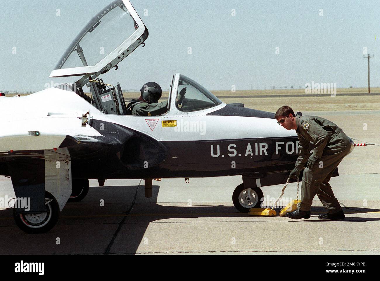CAPT. Jim "Slim" Morgan removes chocks from the T-37 aircraft in ...