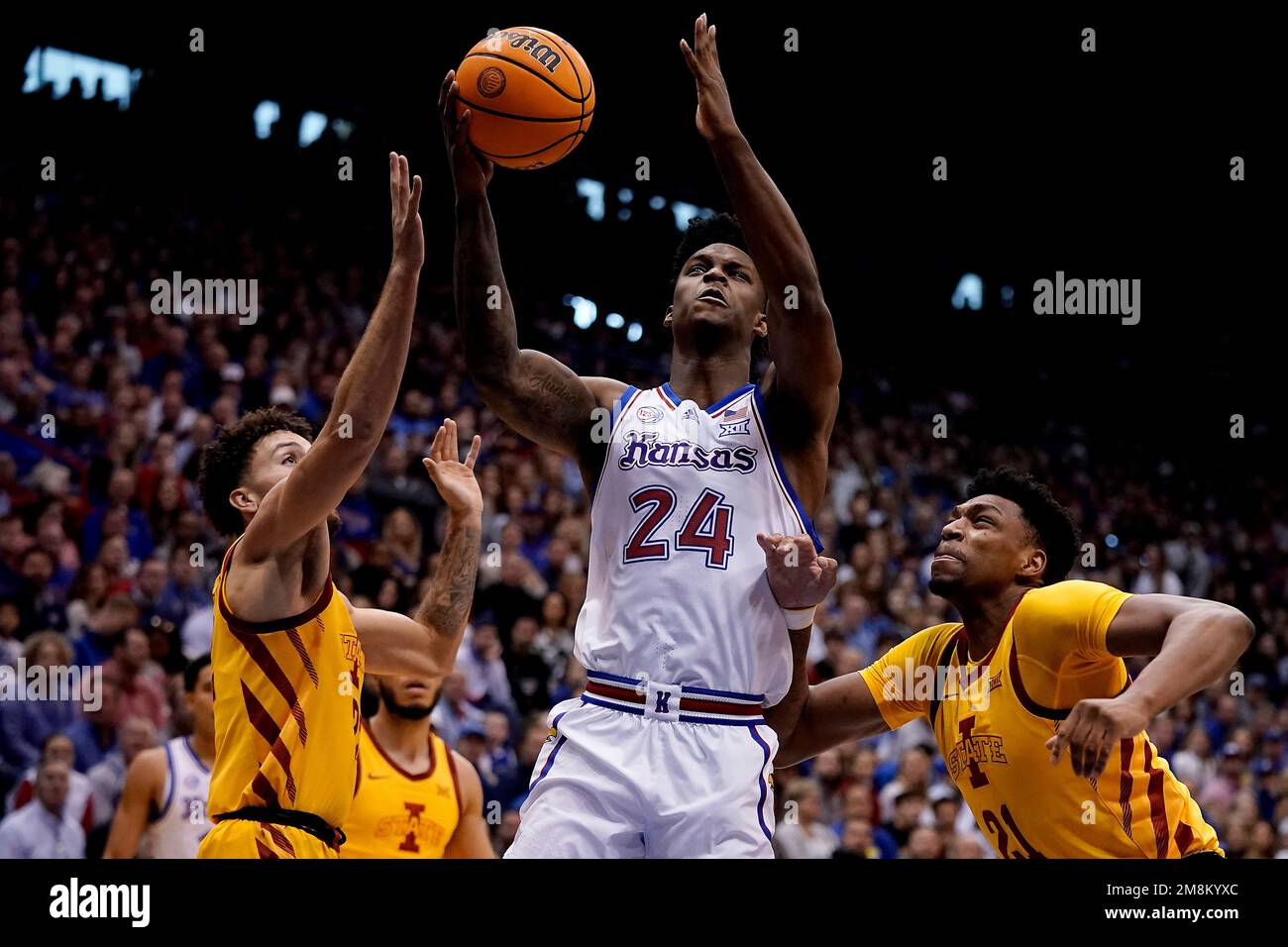 Kansas forward K.J. Adams Jr. (24) shoots between Iowa State guard Gabe Kalscheur, left, and ...