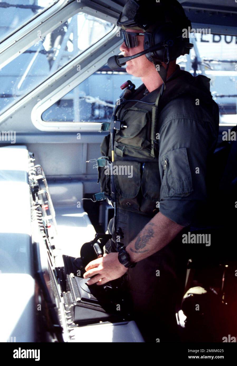 US Navy Quartermaster First Class Michael Harvey controls the throttles ...