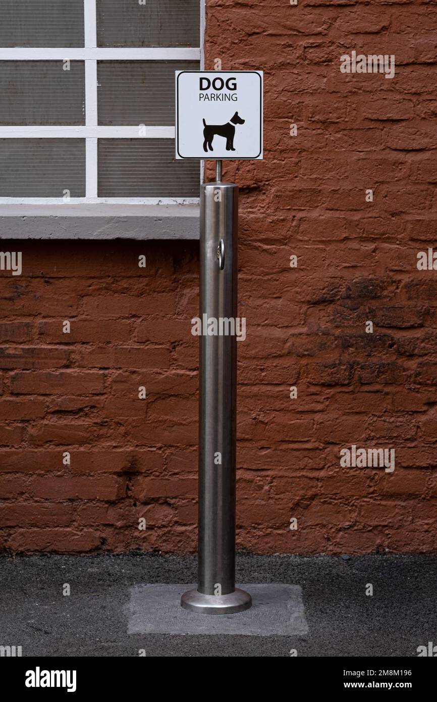 Outdoor parking area for dogs near a supermarket. White-colored sign ...