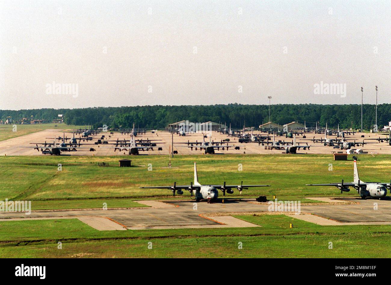 C-130 Hercules aircraft from around the world fill the ramp. They ...