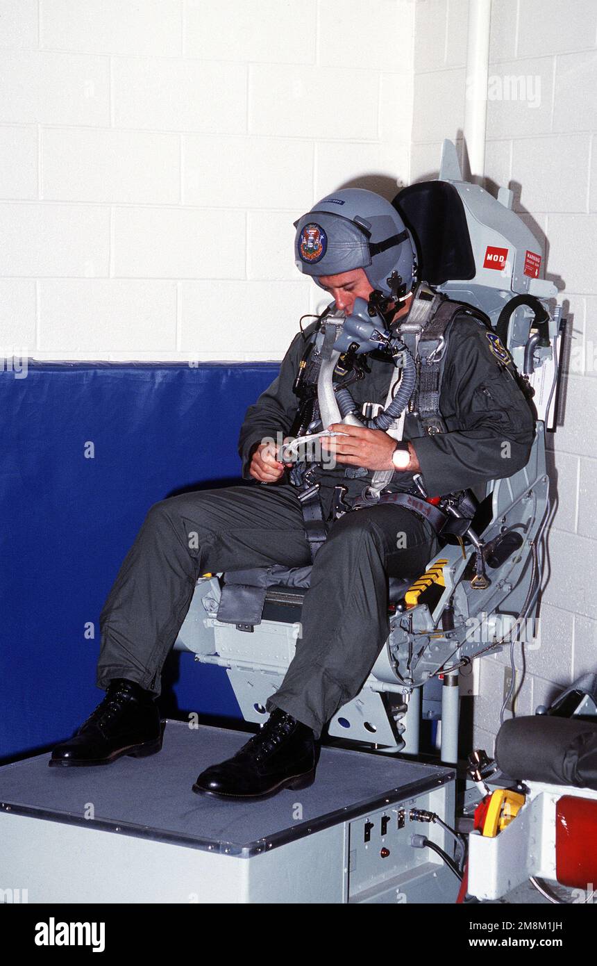 T-38 cockpit security devices are checked by a Naval aviator. The Air Force's joint pilot ...