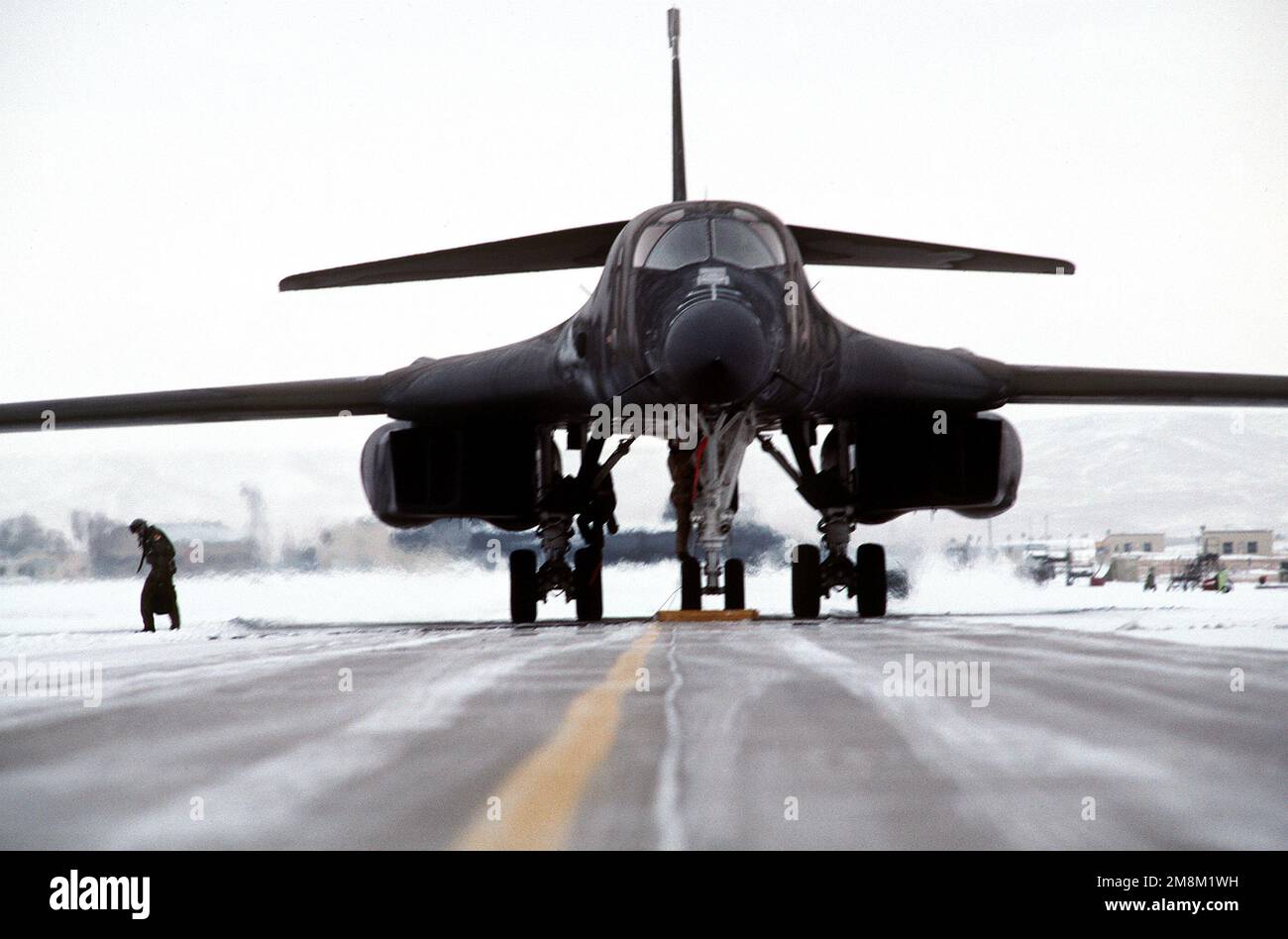 A front view of a B-1B Lancer on the runway as it receives maintenance ...