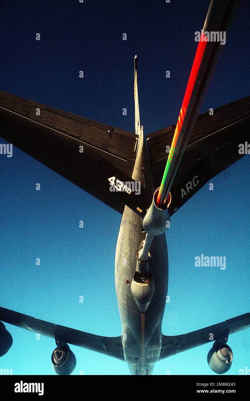 A KC-135 extends its colorful refueling drogue for inflight refueling ...