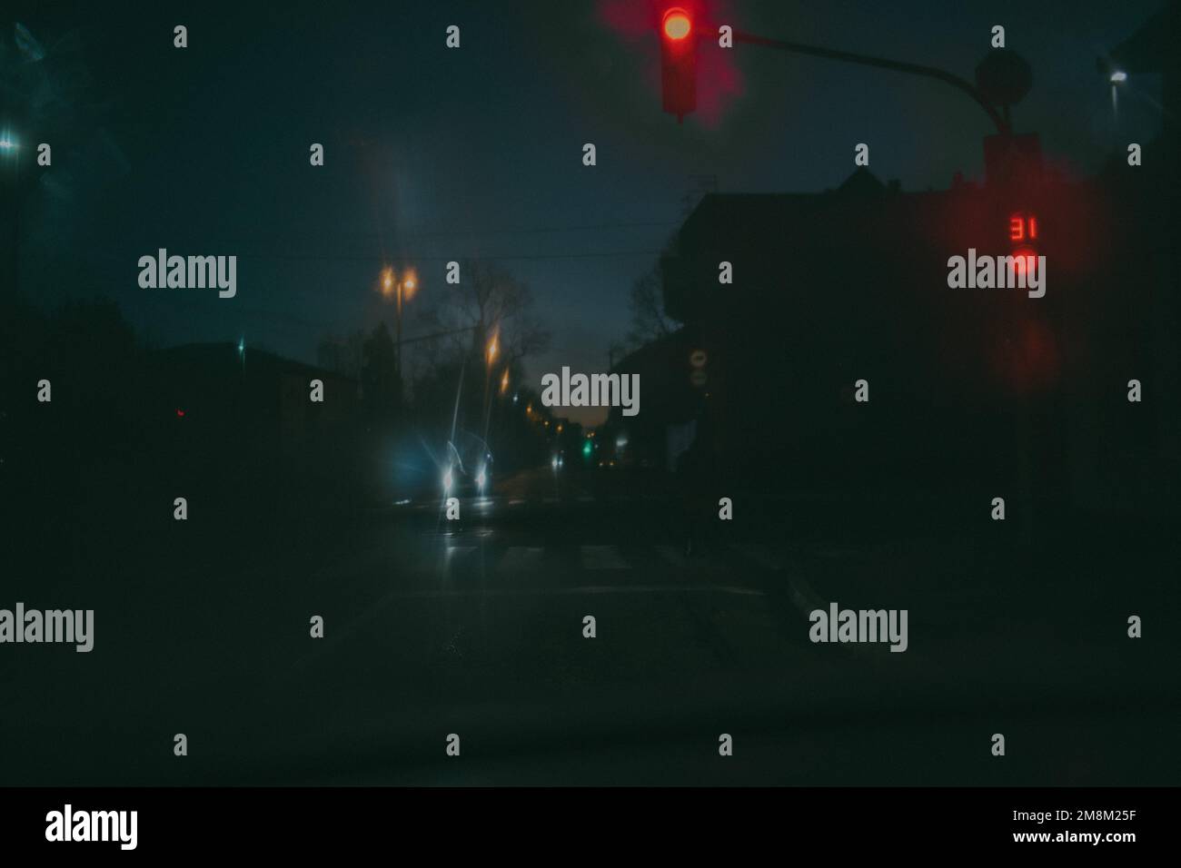 A stop traffic light on the street at night Stock Photo - Alamy