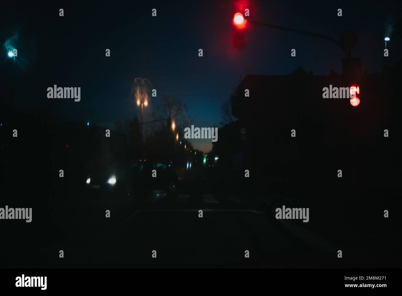 A stop traffic light on the street at night Stock Photo - Alamy