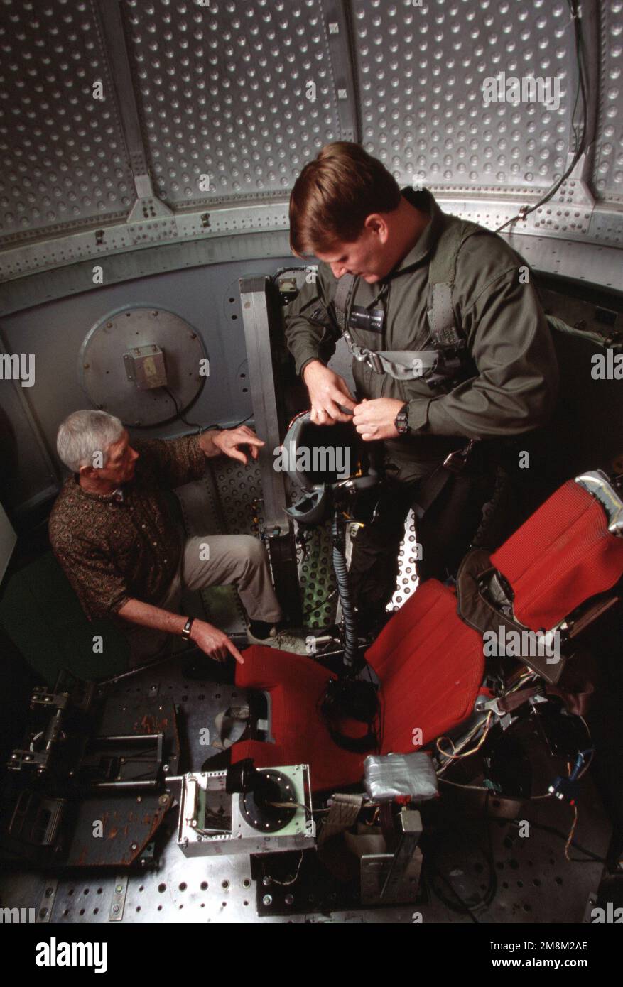 Shot of John Frazier as he straps US Air Force Lieutenant Colonel Bob ...