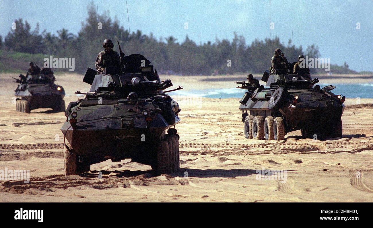 A front view medium shot of three US Marine Corps Light Armored ...