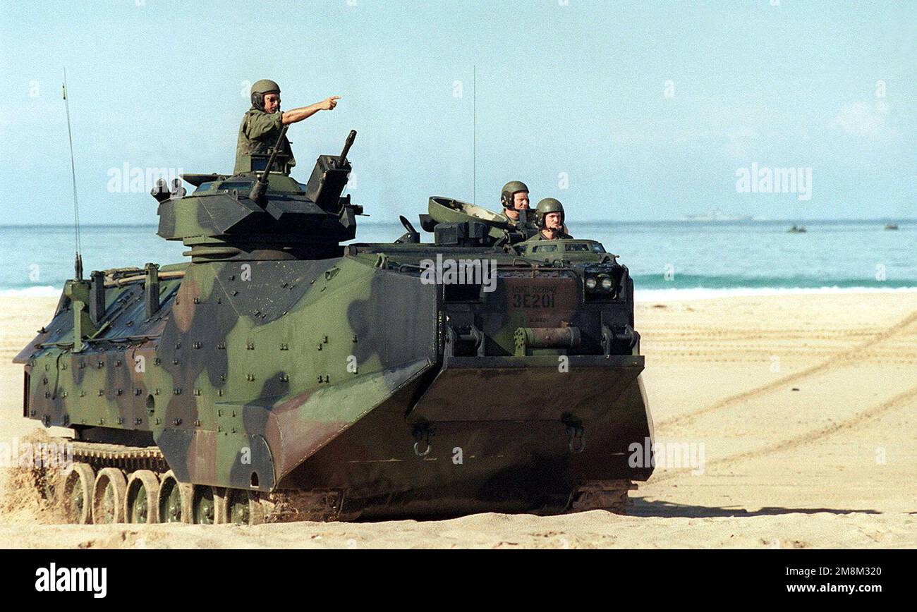 A US Marine Amphibious Assault Vehicle (AAV7A1) maneuvers its way ...