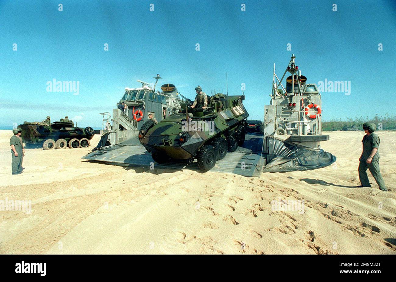 An all-enlisted crew pilots a Landing Craft Air Cushion (LCAC) to the ...