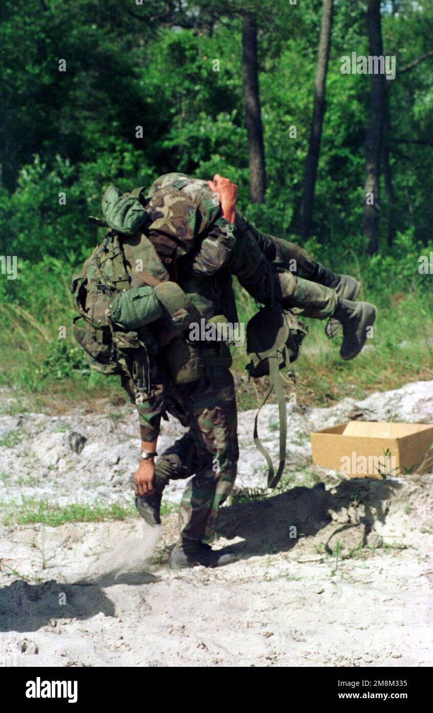 A Marine from Headquarters and Service Company, performs a fireman's ...