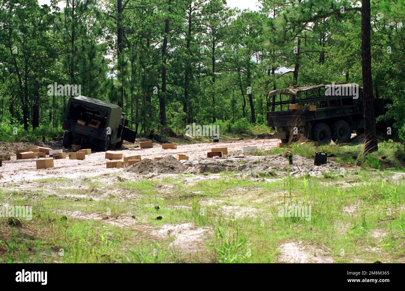 A M1038 High-Mobility Multipurpose Wheeled Vehicle (HMMWV) and a 5-ton ...