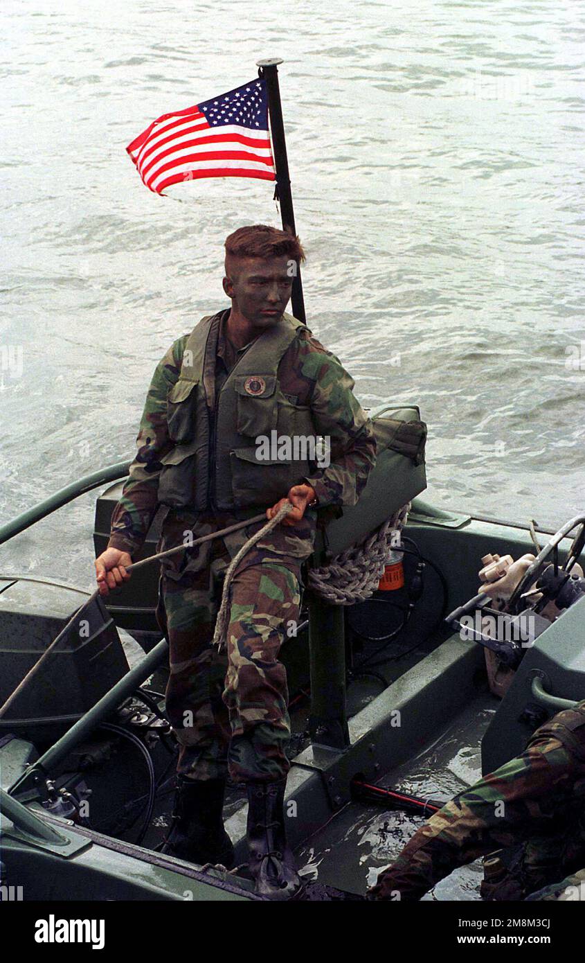 A US Marine from Small Craft Company, 2ND Marine Division, waits aboard ...