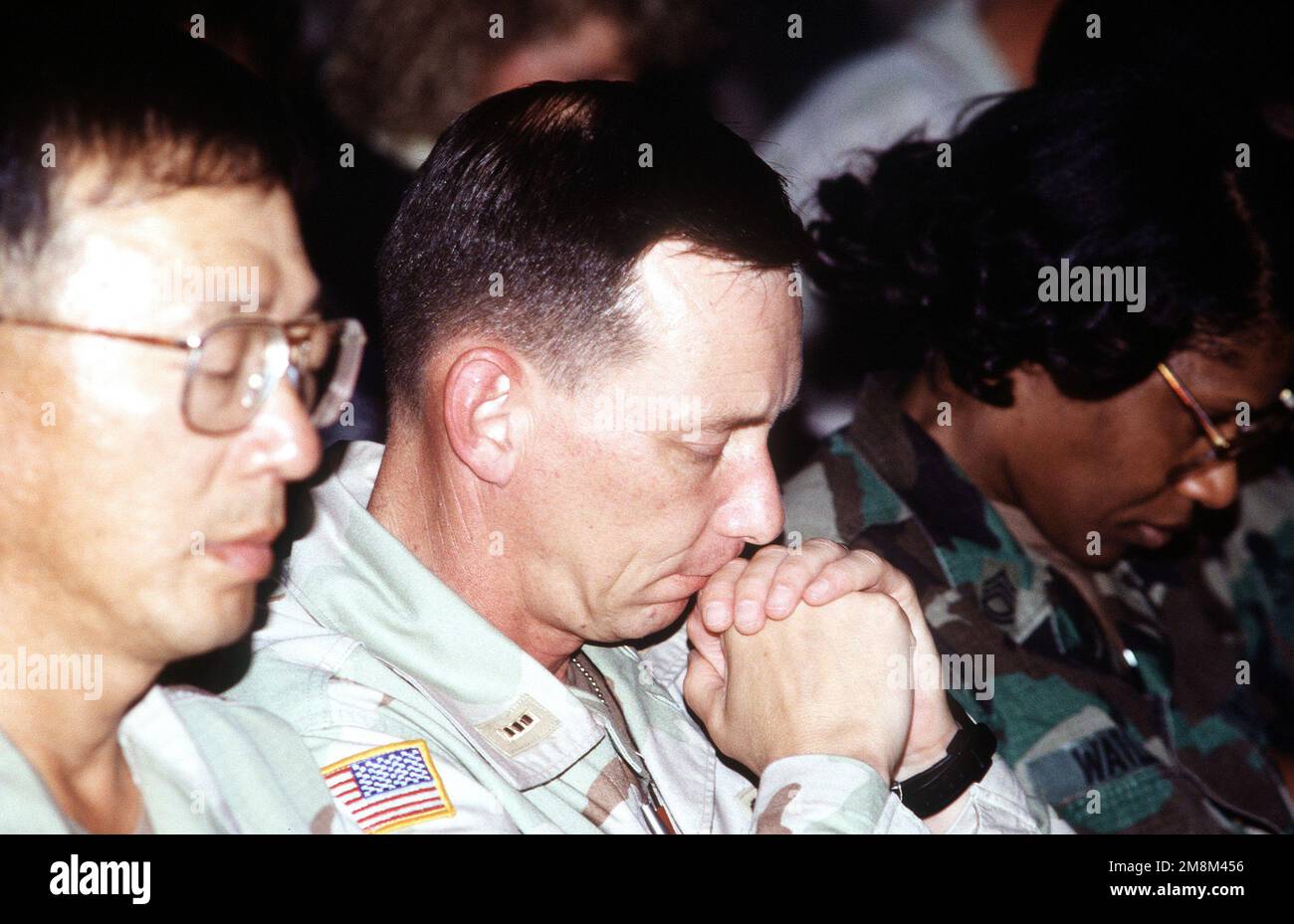 Members of the 4404th Operation Support Group pray for the victims ...