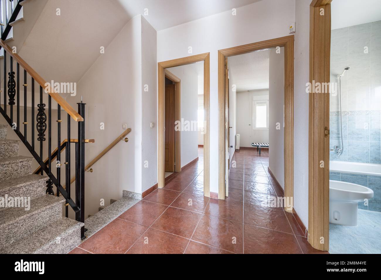 Interior staircase of a single family residential house with red tile ...