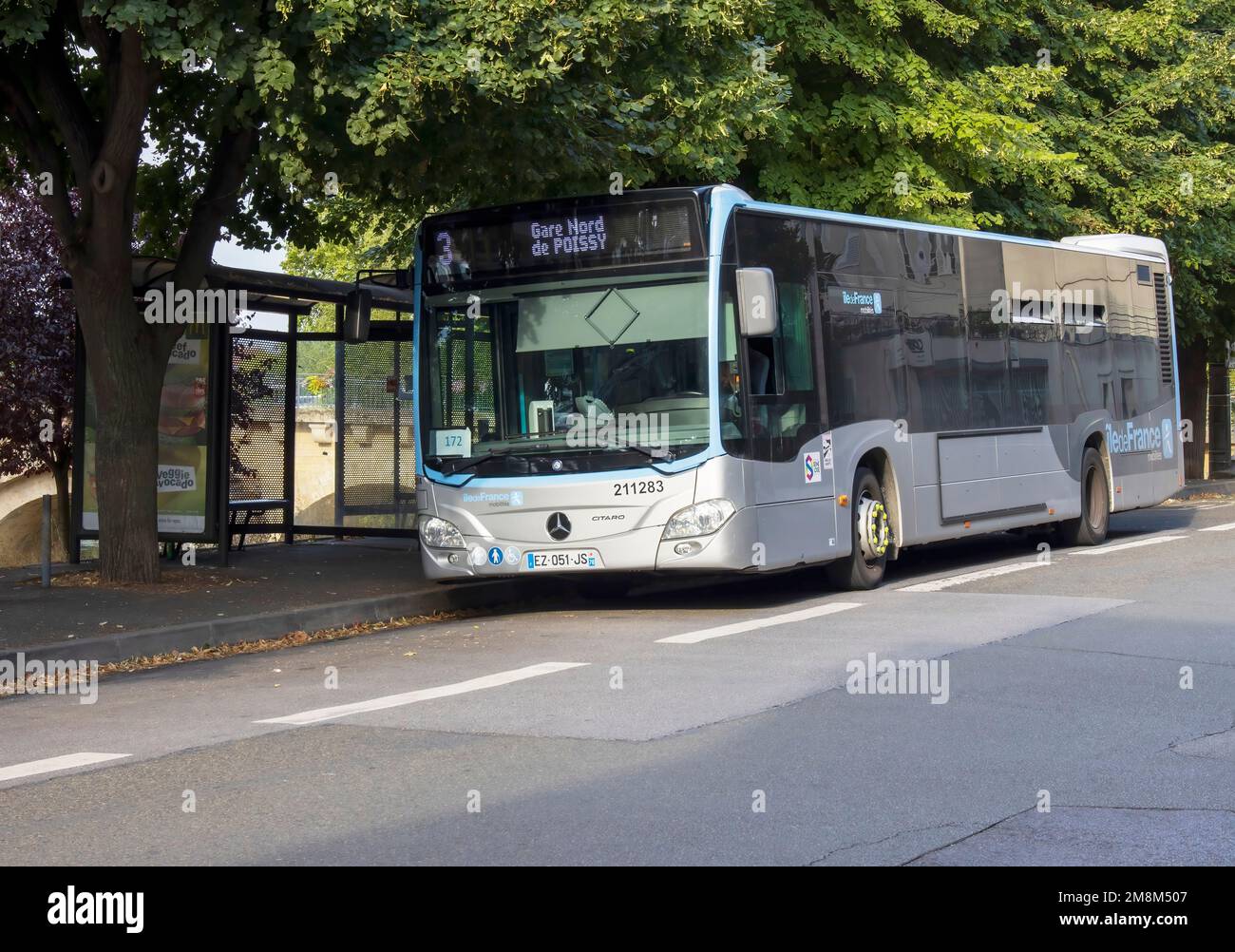 A Bus waiting for passengers at the station under trees in Meulan-en ...
