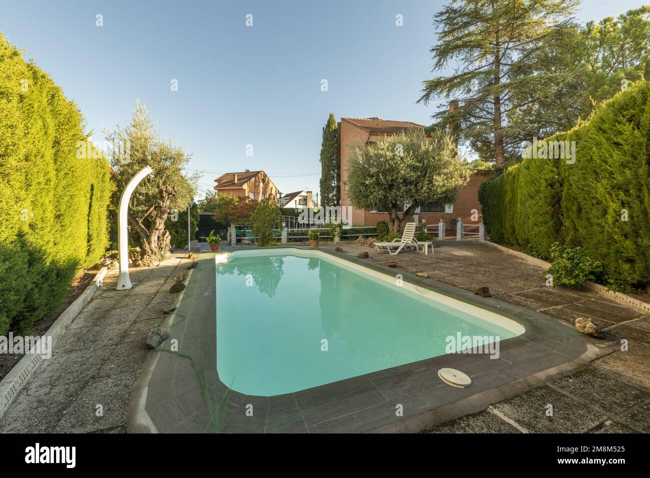 Pool of a detached house with a plot paved with stone slabs with the ...