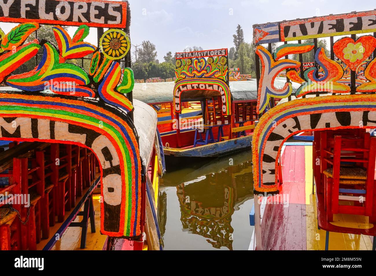 Colorful painted trajinera boats waiting for tourists to travel the ...