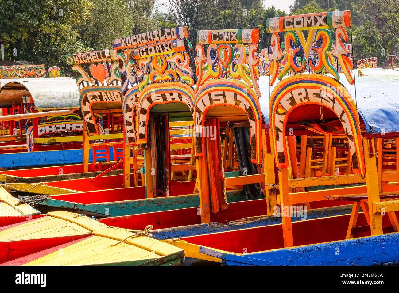 Colorful painted trajinera boats waiting for tourists to travel the ...