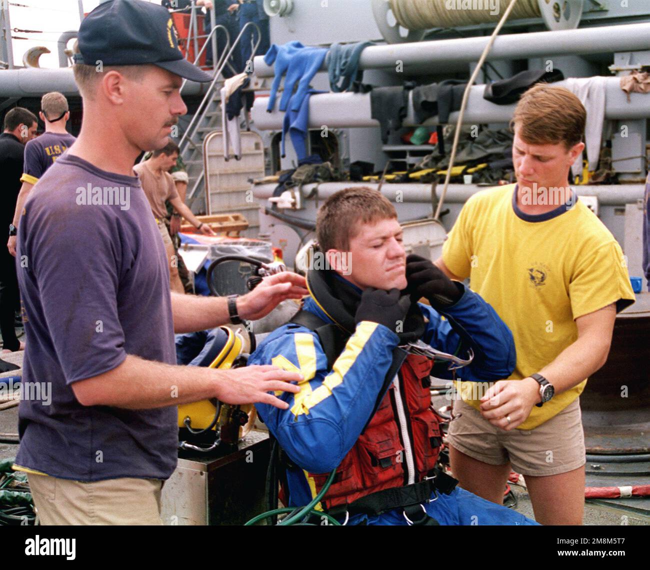 US Navy Diver Hull Technician 2nd Class (DV) Brad Fleming is being prepared for his next dive ...