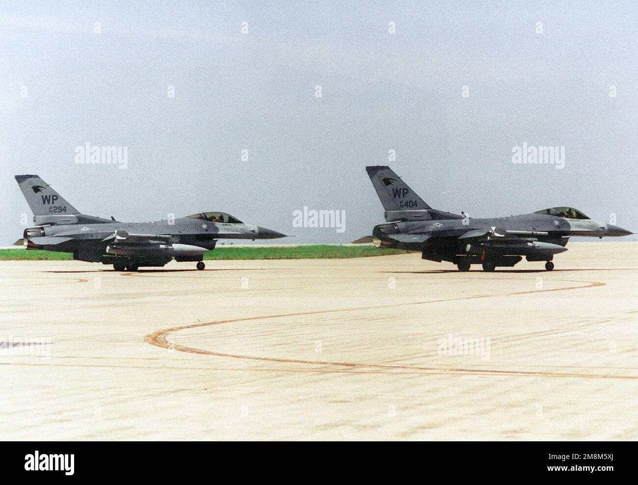 A right side view of two US Air Force F-16 Fighting Falcons on the ...