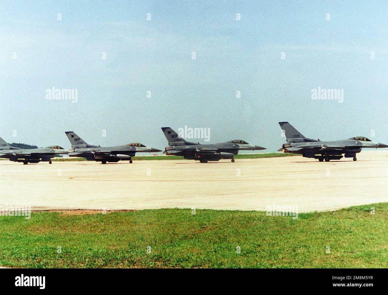 Four US Air Force F-16 Fighting Falcons on the flight line. Subject ...