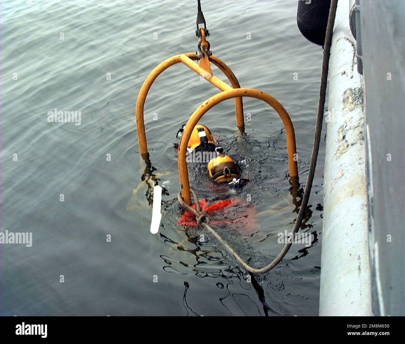 US Navy MASTER Diver Eric Frank and Diver James Mariano from Mobile Diving Salvage Unit 2 are ...