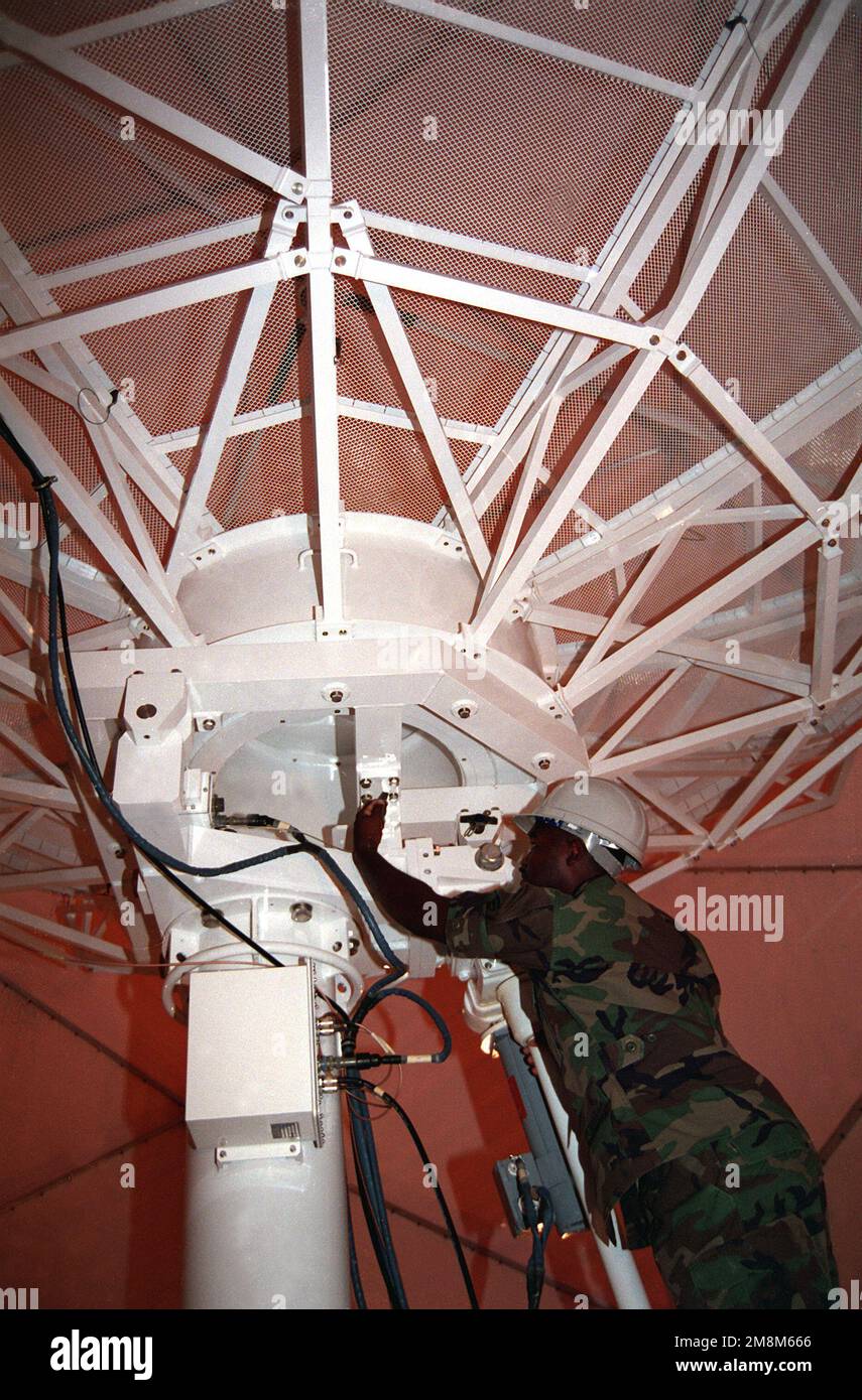 Benton Boltin, 18th Communications Squadron, makes adjustments to the ...
