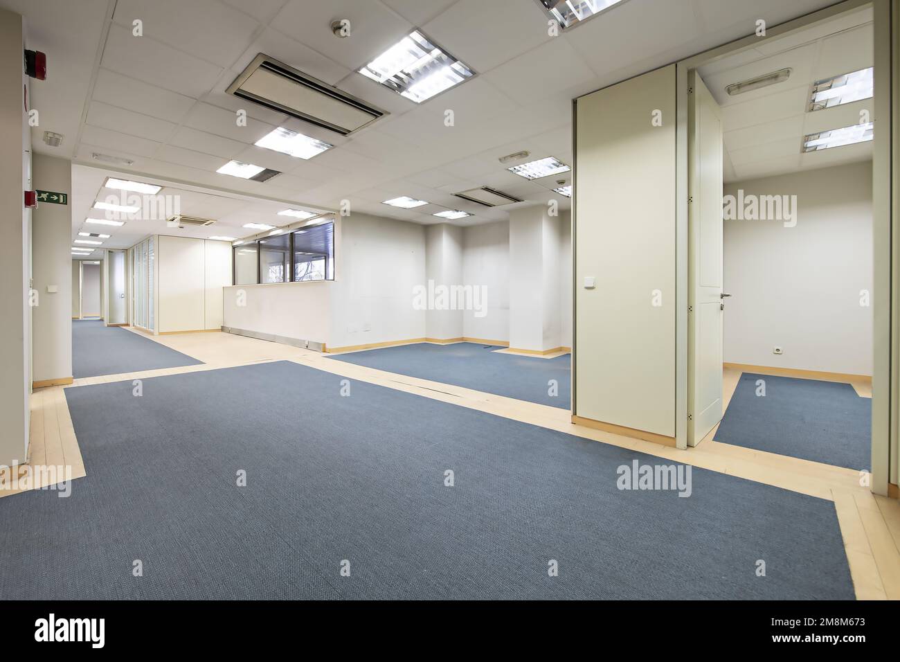 Rooms of an empty office with one with windows, technical ceilings ...