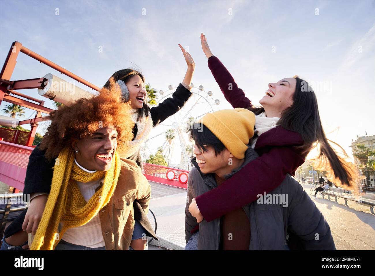 Cheerful two couple walking outdoors in a theme park and having fun ...
