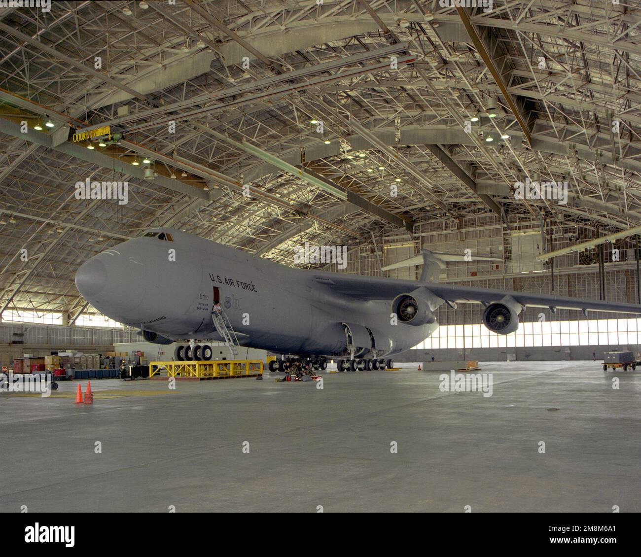 Side view of C-5 Aircraft in Weight and Balance hangar. Process is ...