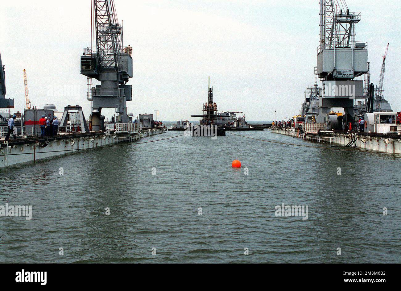 The US Navy Attack Submarine USS OKLAHOMA CITY (SSN 723) takes position ...