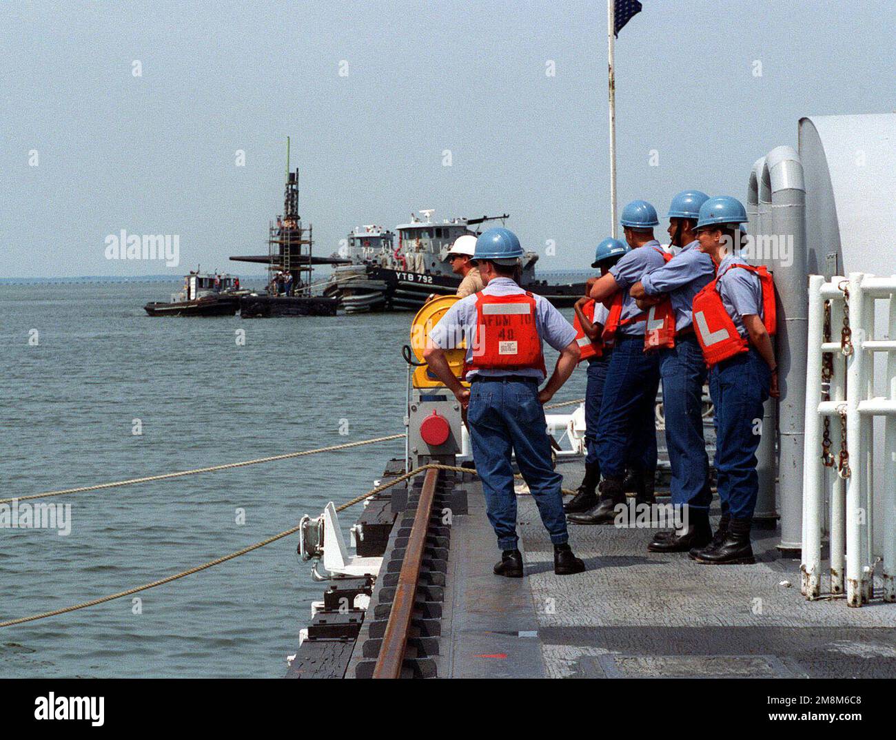 Line handlers assigned to the US Navy's medium auxiliary floating dry ...