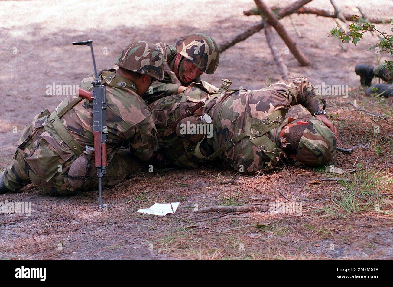 US Marine Corps soldiers assist their wounded comrade during ...