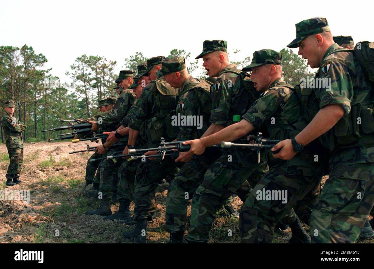 A US Marine instructor observes as Estonian Soldiers armed with 5.56mm ...