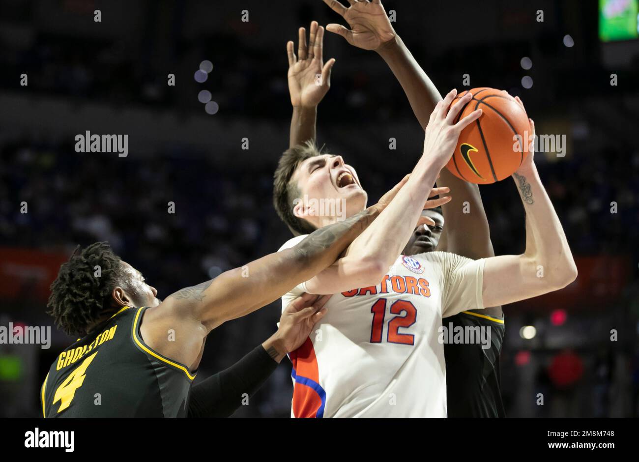 Florida forward Colin Castleton (12) gets fouled by Missouri guard ...