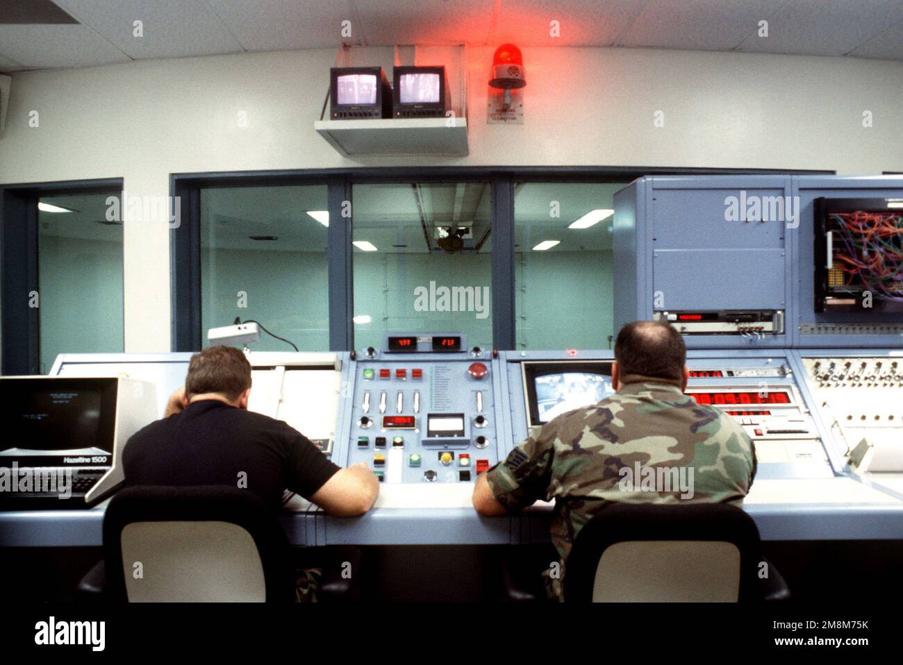 STAFF SGT. Mark Regna (right) sits behind the glass in the observer ...