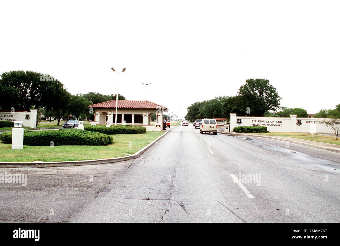 The base sign at the main gate displays four headquarters shields. Base ...
