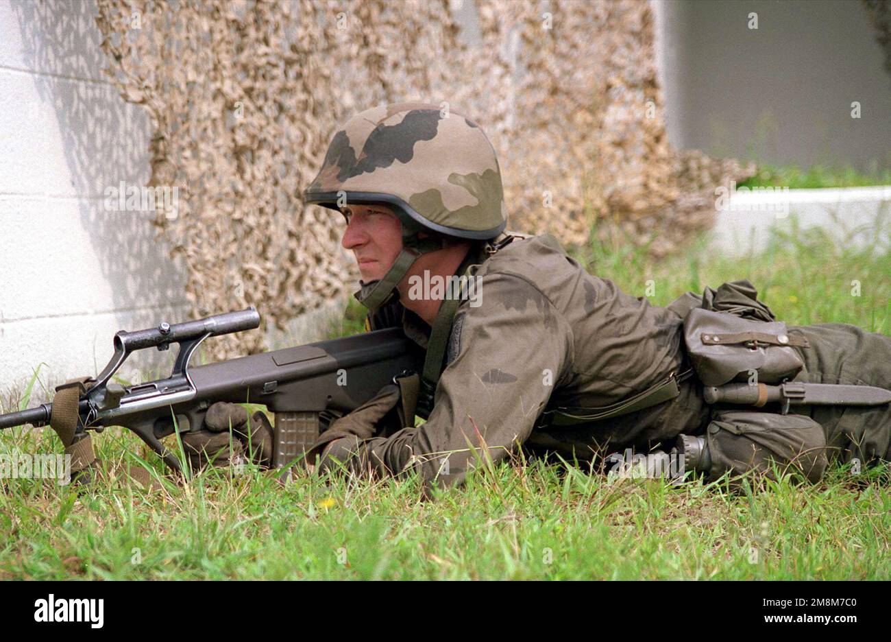 An Austrian soldier armed with a Steyr AUG rifle provides security ...