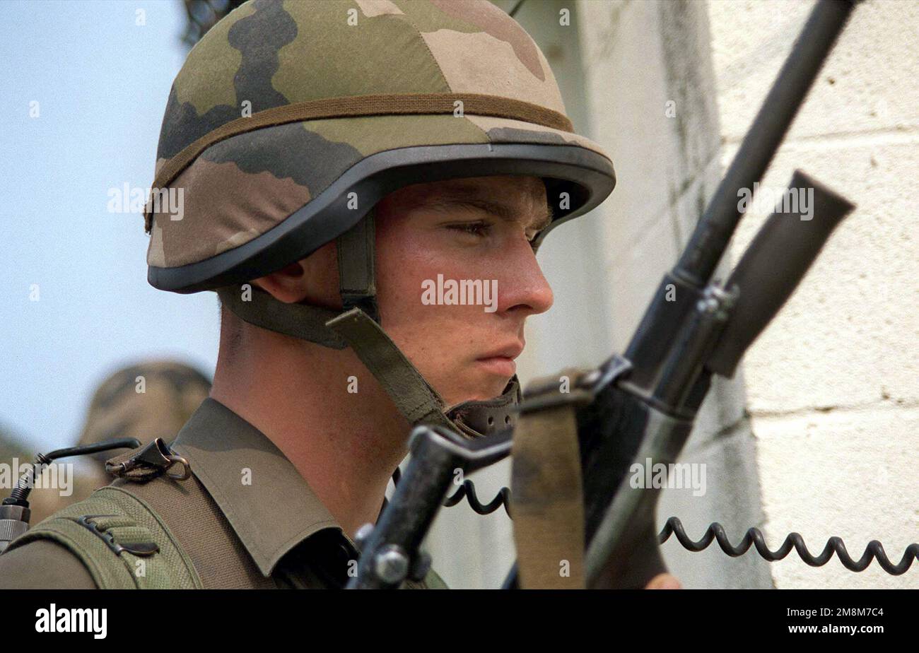 An Austrian radioman armed with a Steyr AUG rifle stands by for further ...