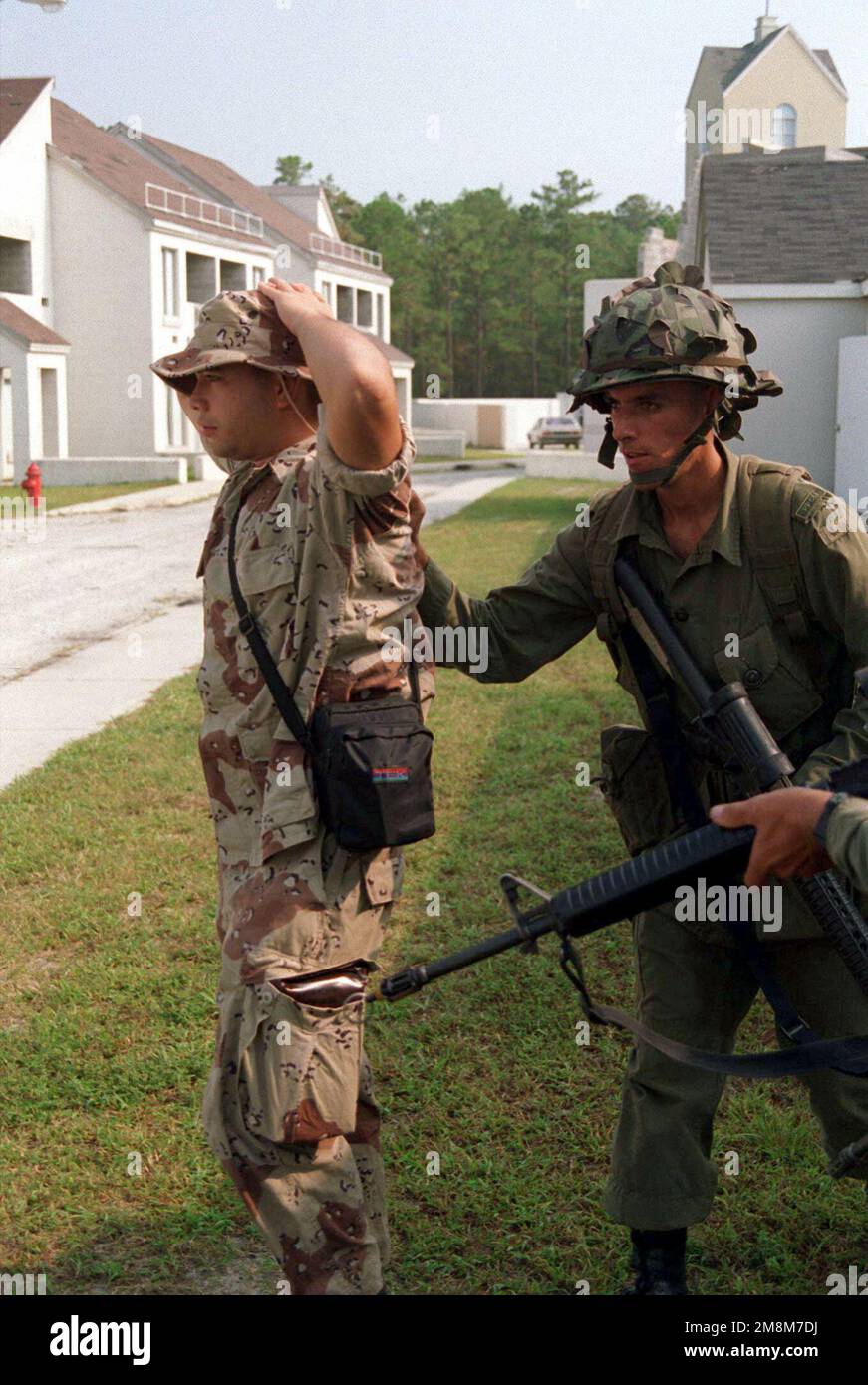 Canadian soldiers armed with M16A2 assault rifles arrest a hostile ...