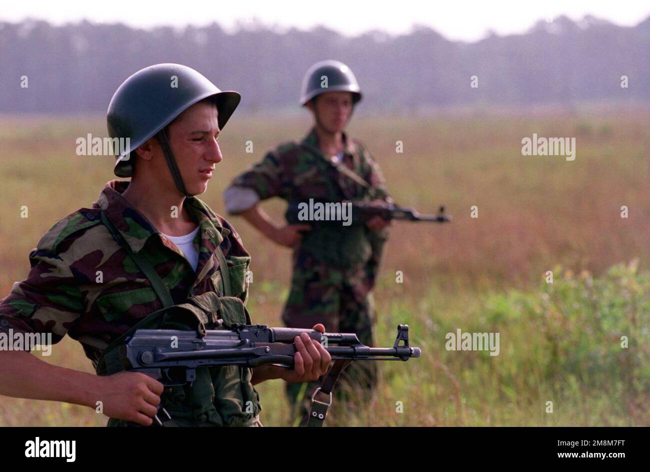 Albanian Soldiers armed with the 7.62mm AKMS assault rifle, patrol ...