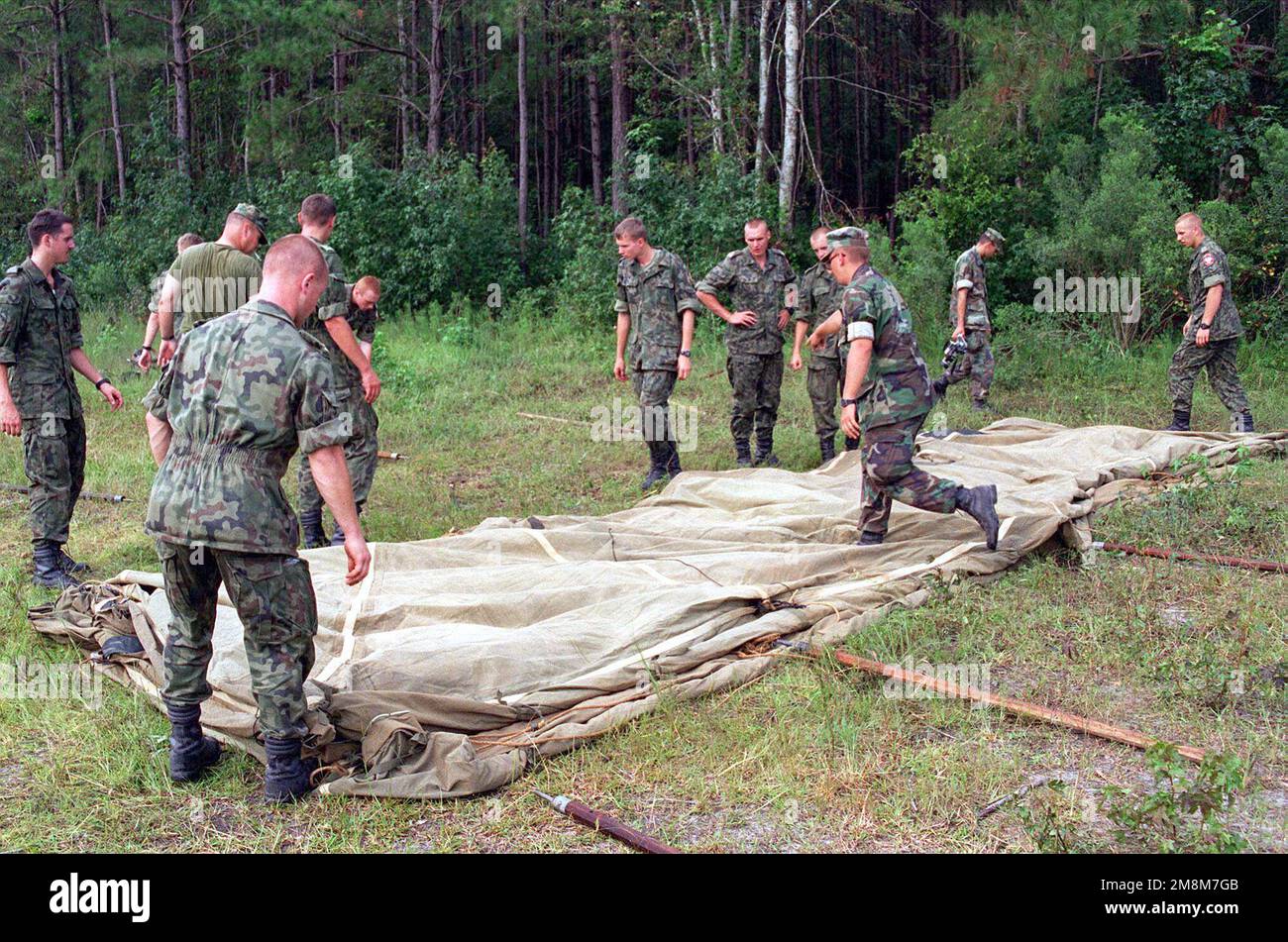 960826-M-8708Y-003. [Complete] Scene Caption: US Marines help Polish ...